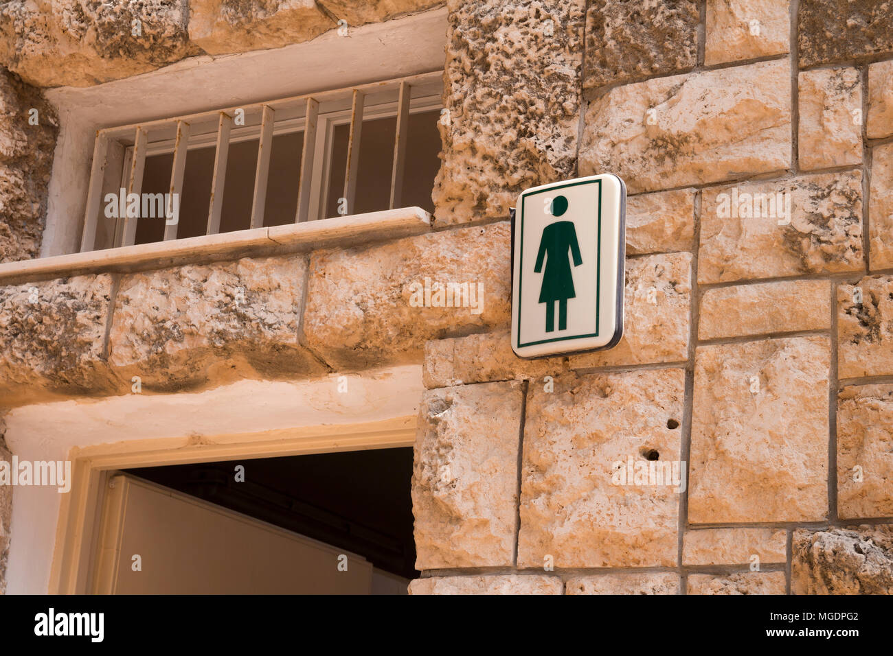 Public modern white and green woman restroom sign on stone wall Stock ...
