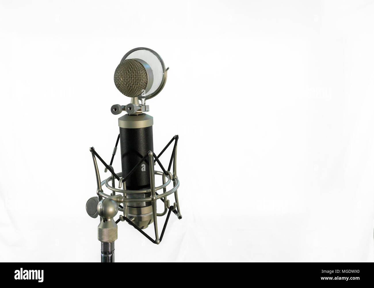 Vocal condenser microphone with wind screen isolated on white ...