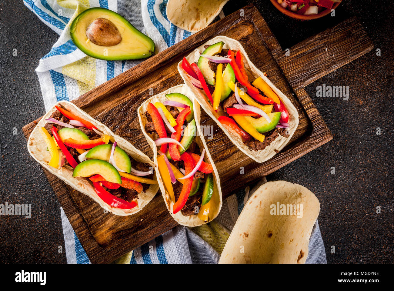 Homemade Mexican pork tacos with vegetables and salsa, on dark rusty ...