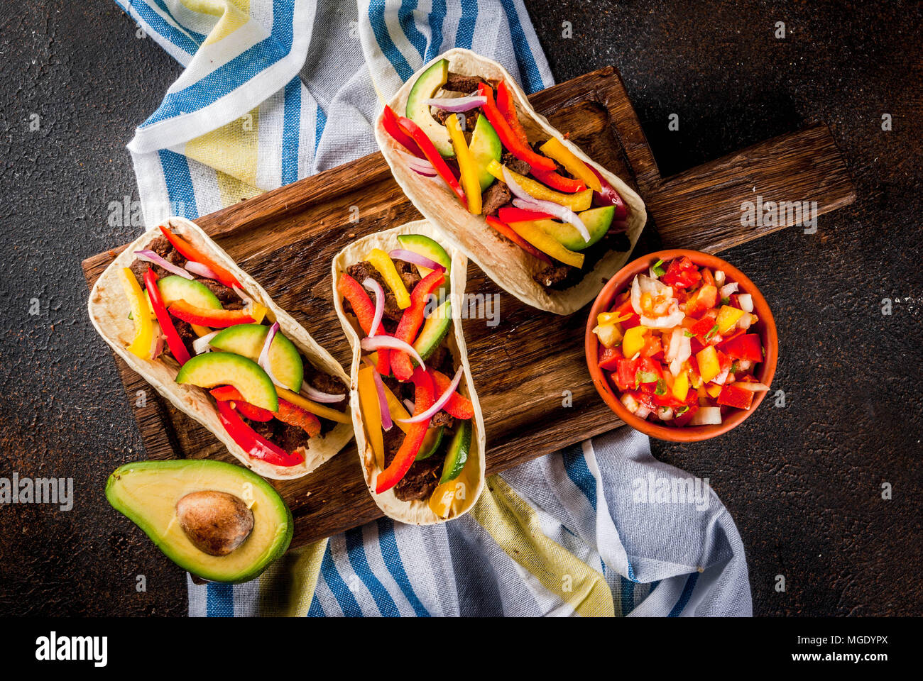 Homemade Mexican pork tacos with vegetables and salsa, on dark rusty ...