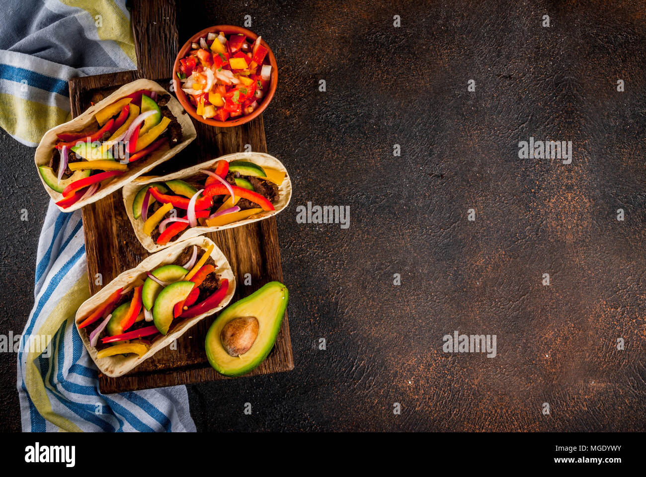 Homemade Mexican pork tacos with vegetables and salsa, on dark rusty ...