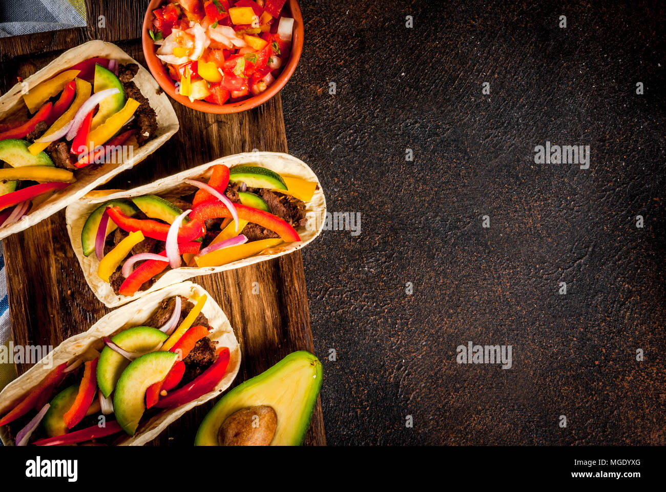 Homemade Mexican pork tacos with vegetables and salsa, on dark rusty ...
