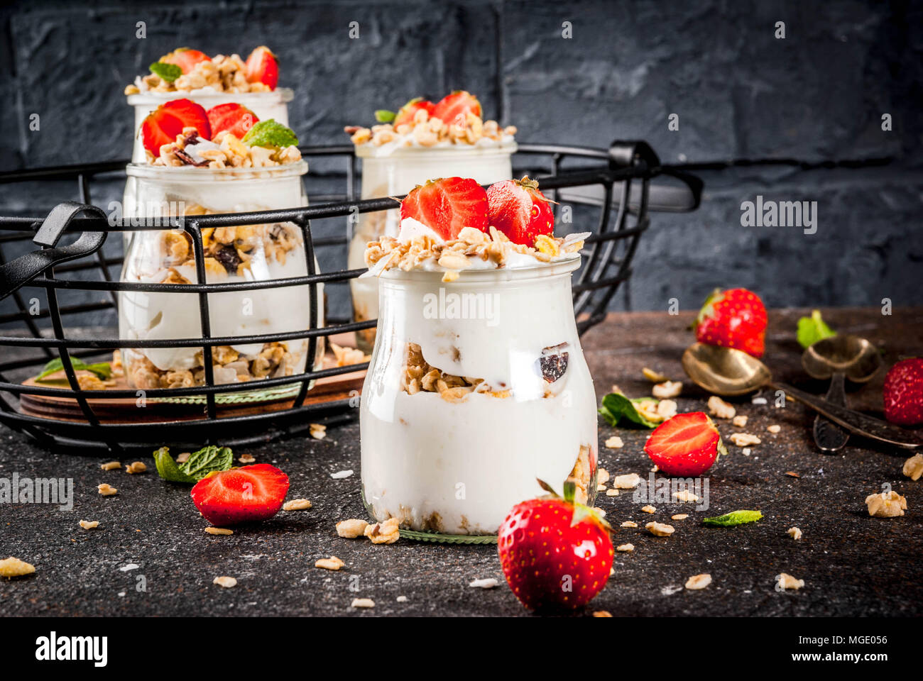 Healthy summer breakfast idea, homemade layered parfe dessert in small ...