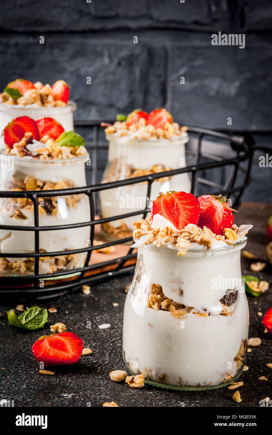 Healthy summer breakfast idea, homemade layered parfe dessert in small ...