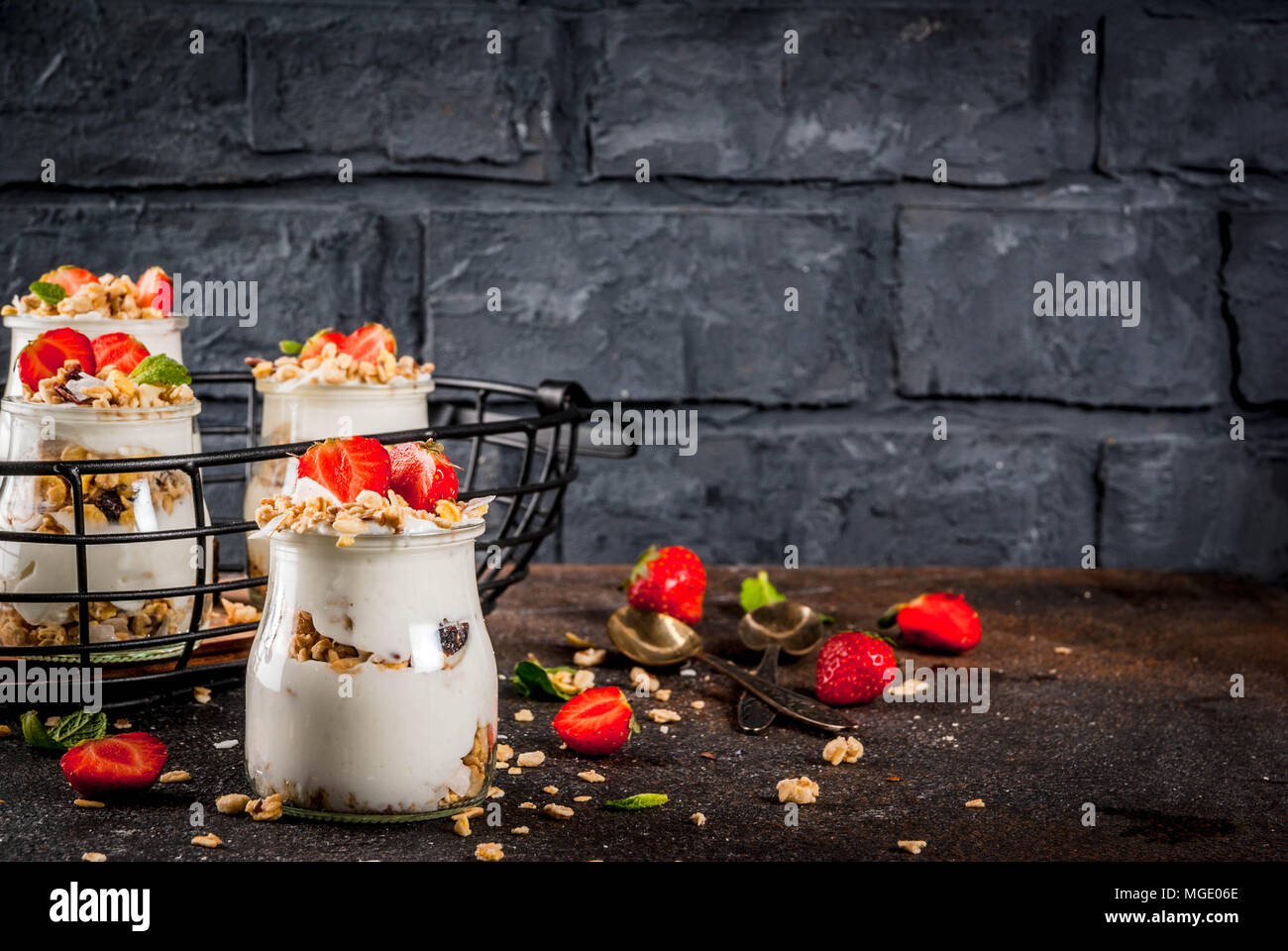 Healthy summer breakfast idea, homemade layered parfe dessert in small ...