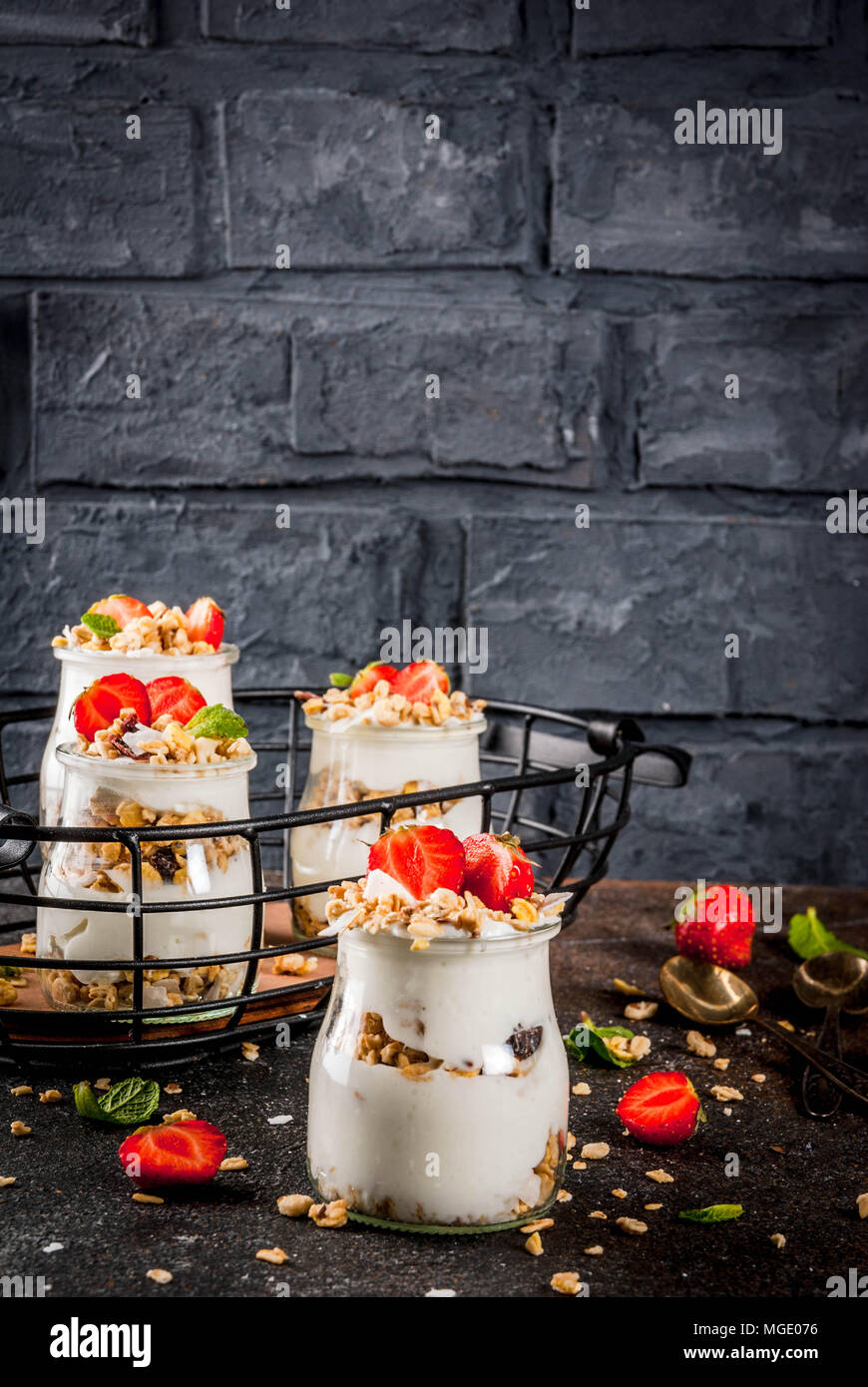 Healthy summer breakfast idea, homemade layered parfe dessert in small ...