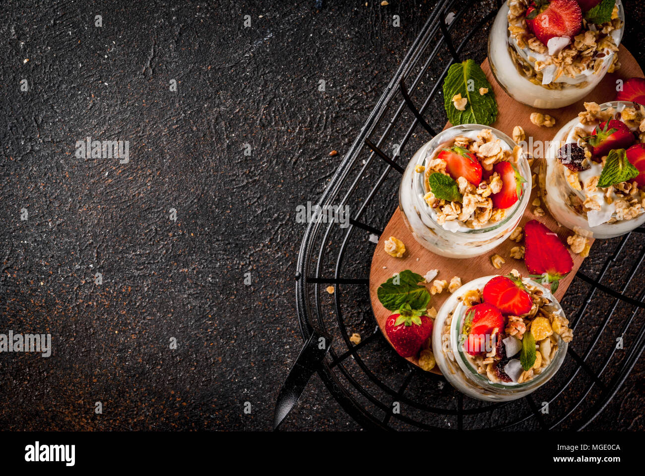 Healthy summer breakfast idea, homemade layered parfe dessert in small ...