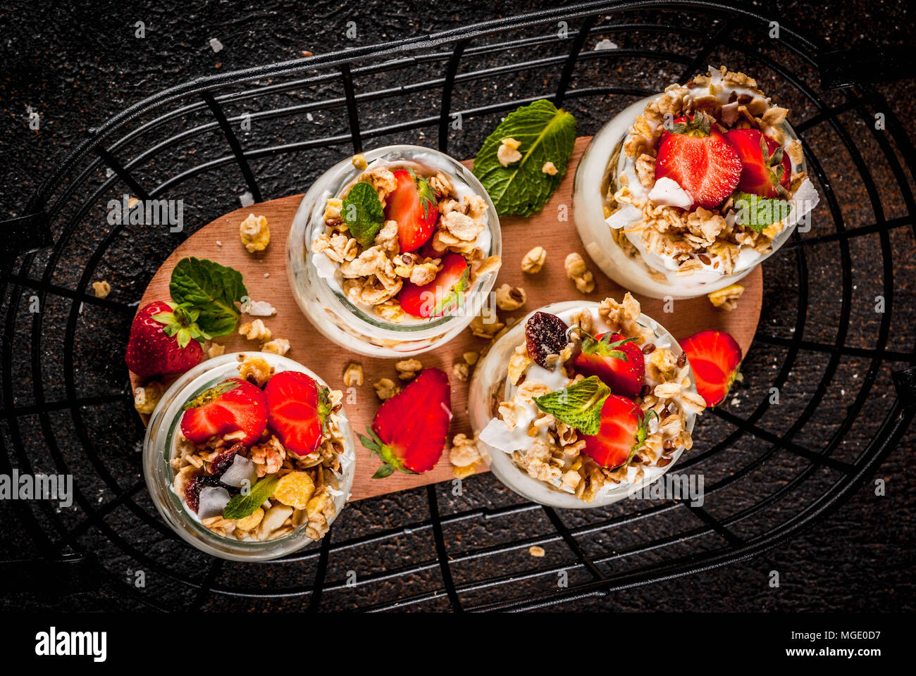 Healthy summer breakfast idea, homemade layered parfe dessert in small ...