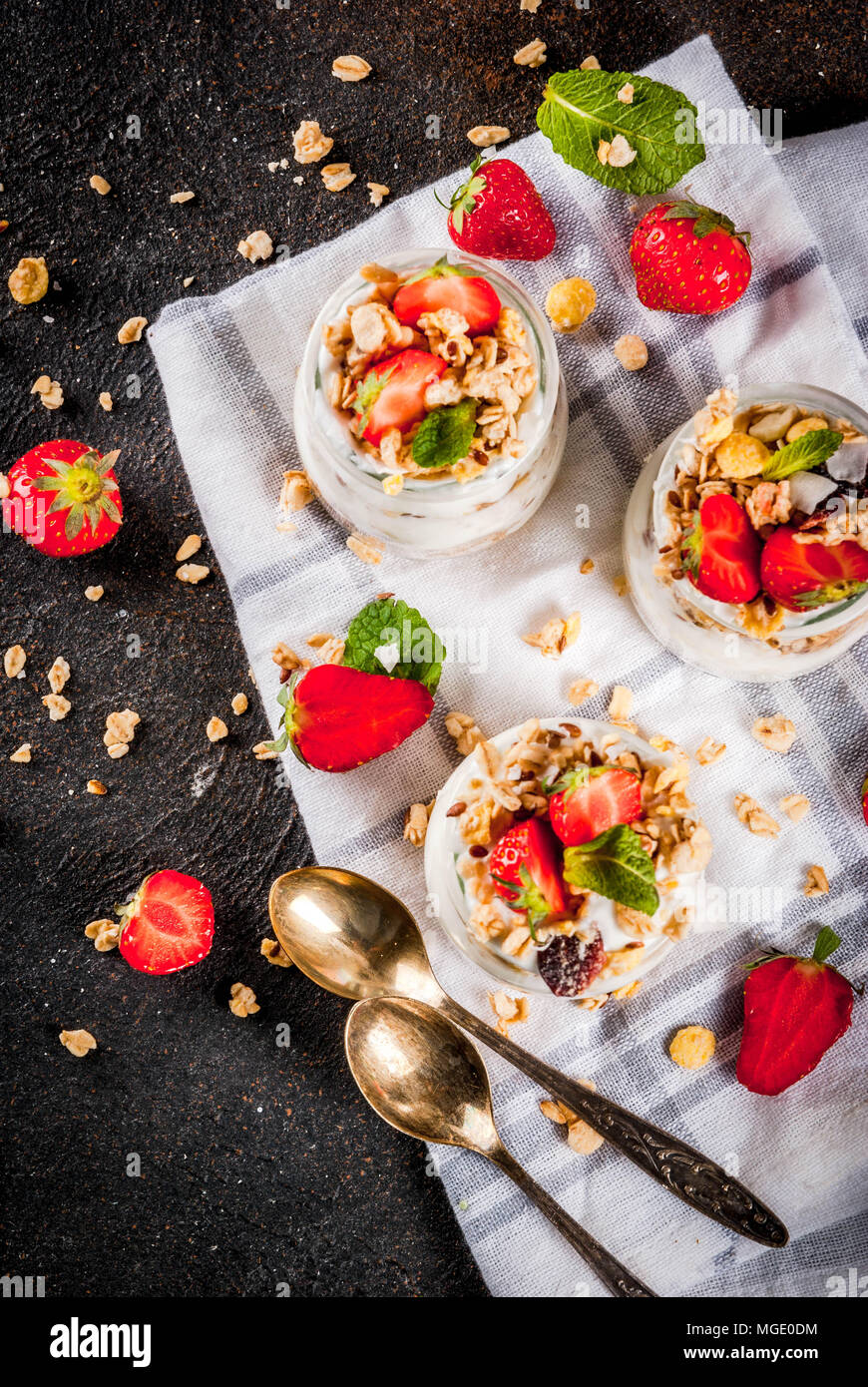 Healthy summer breakfast idea, homemade layered parfe dessert in small ...