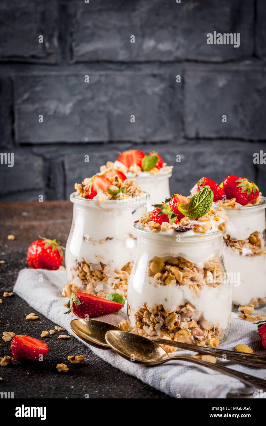 Healthy summer breakfast idea, homemade layered parfe dessert in small ...