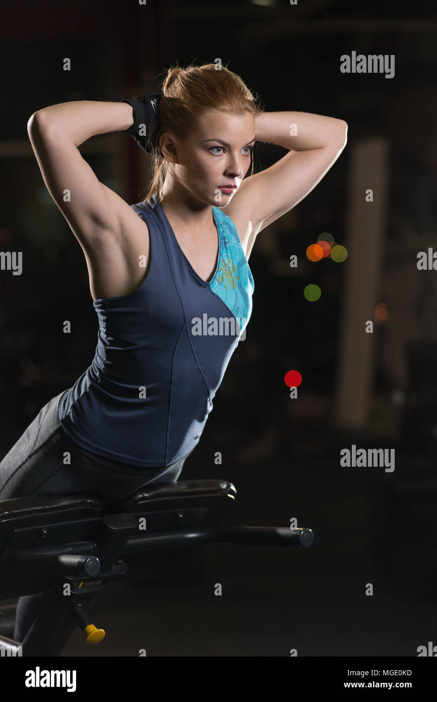 Woman doing strength exercises for abs muscles Stock Photo - Alamy