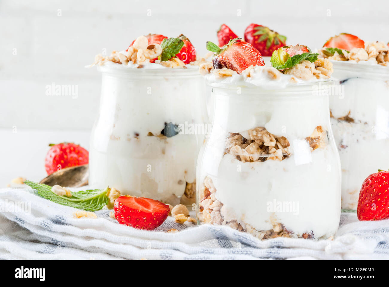 Healthy summer breakfast idea, homemade layered parfe dessert in small ...