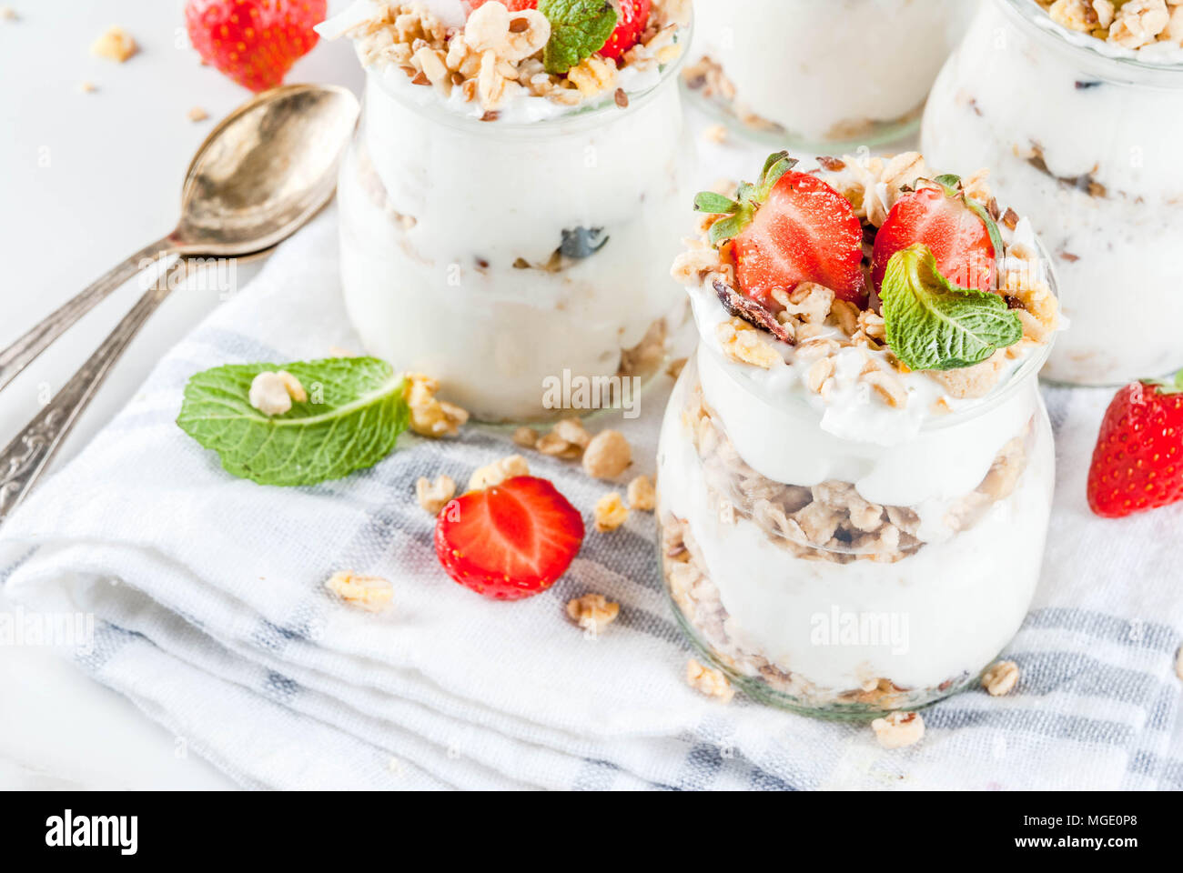 Healthy summer breakfast idea, homemade layered parfe dessert in small ...