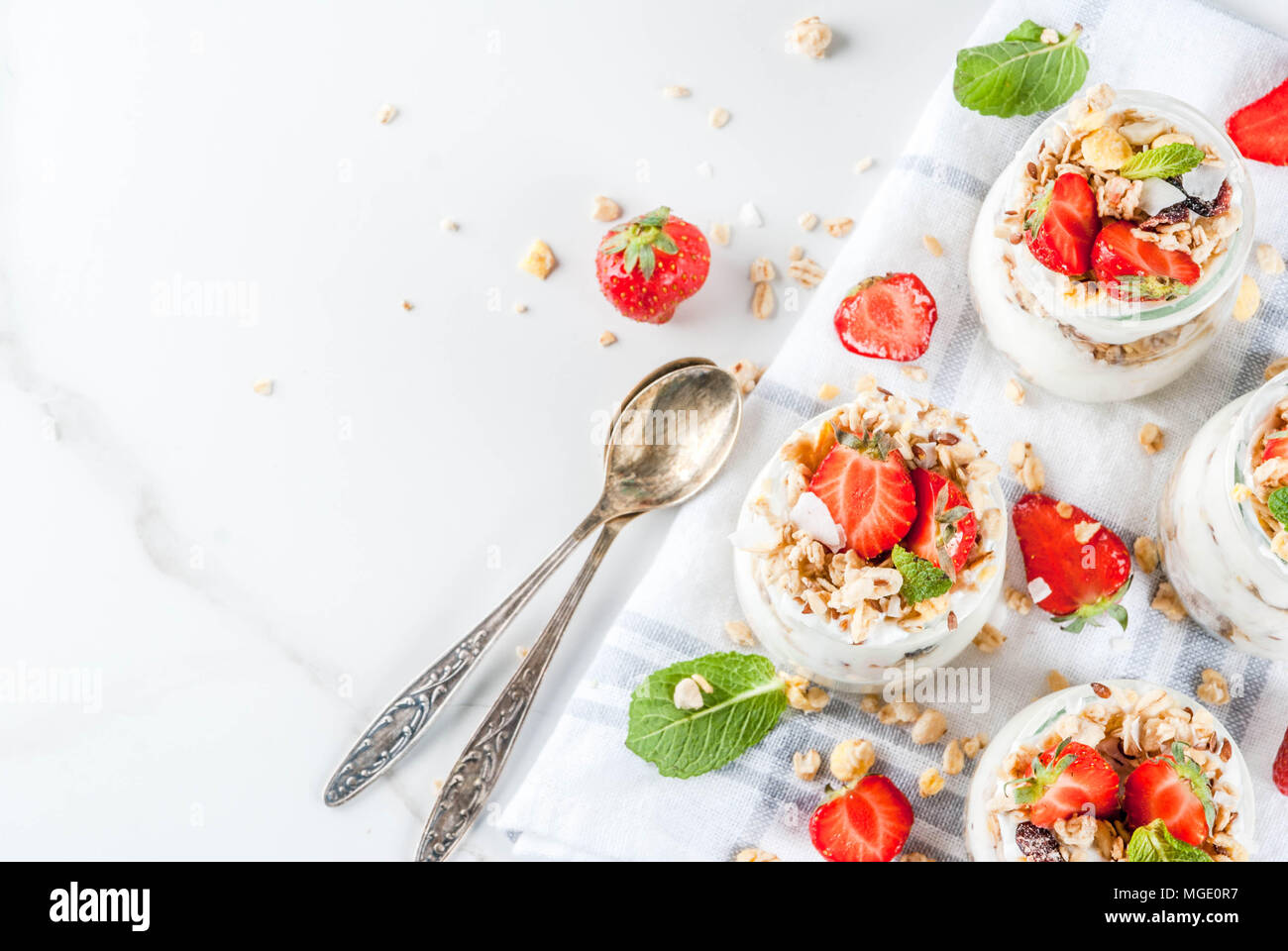 Healthy summer breakfast idea, homemade layered parfe dessert in small ...