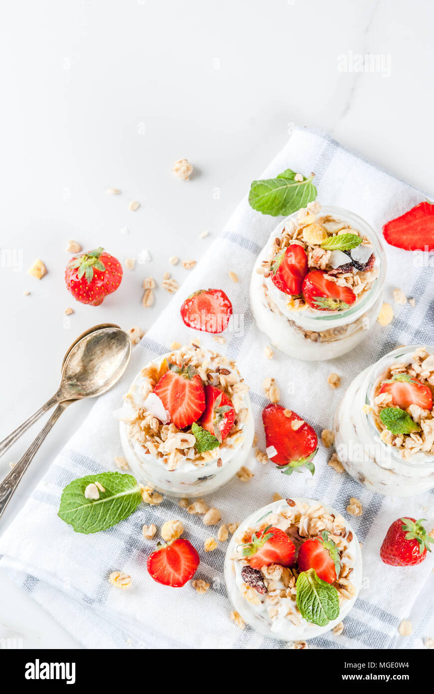 Healthy summer breakfast idea, homemade layered parfe dessert in small ...