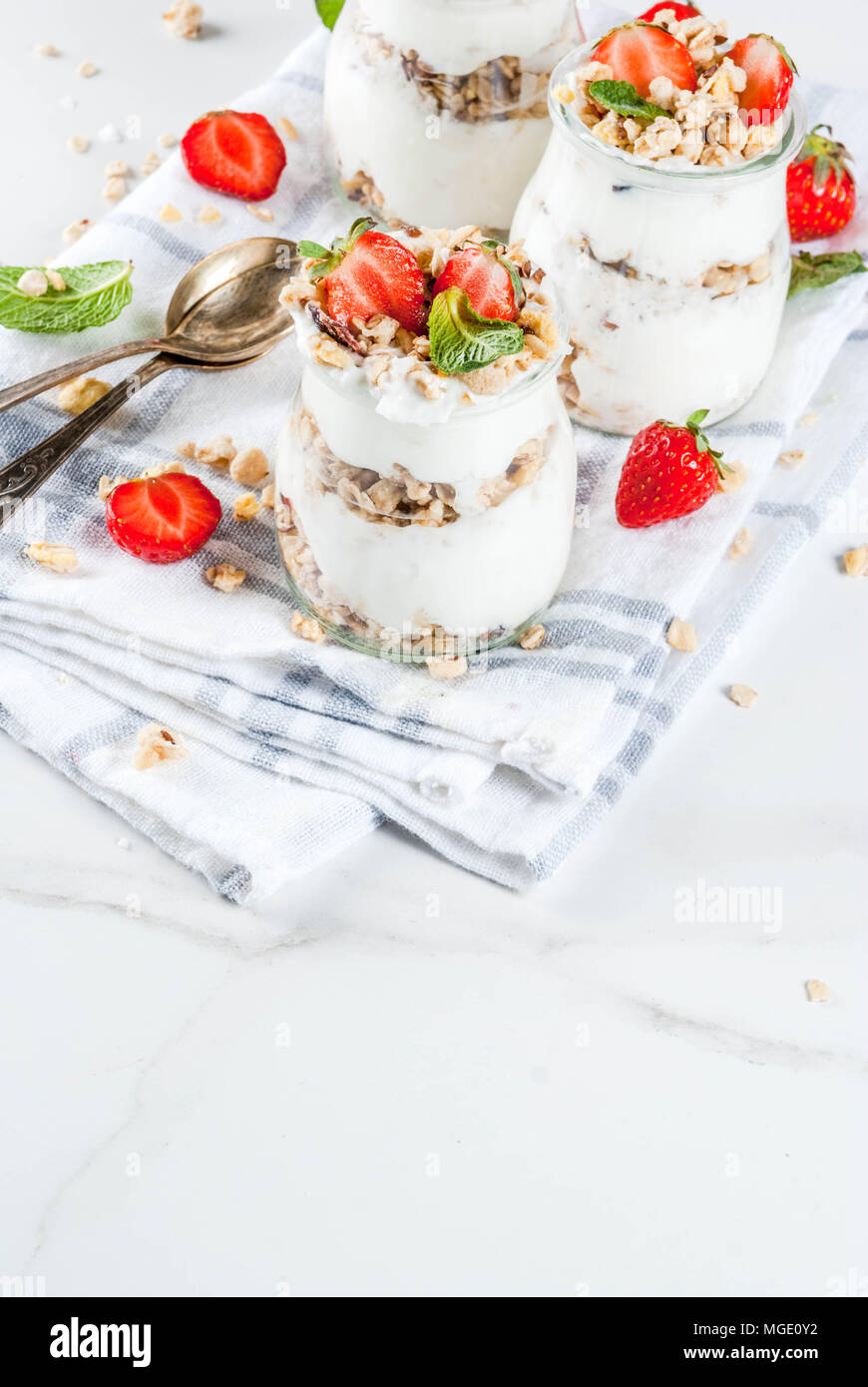Healthy summer breakfast idea, homemade layered parfe dessert in small ...