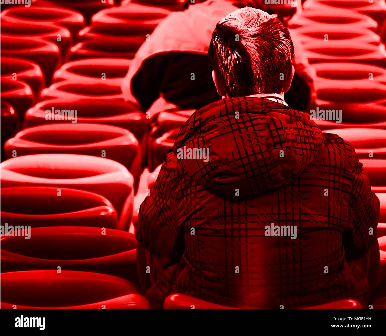 Lonely football soccer fan at empty stadium. Red toned Stock Photo - Alamy