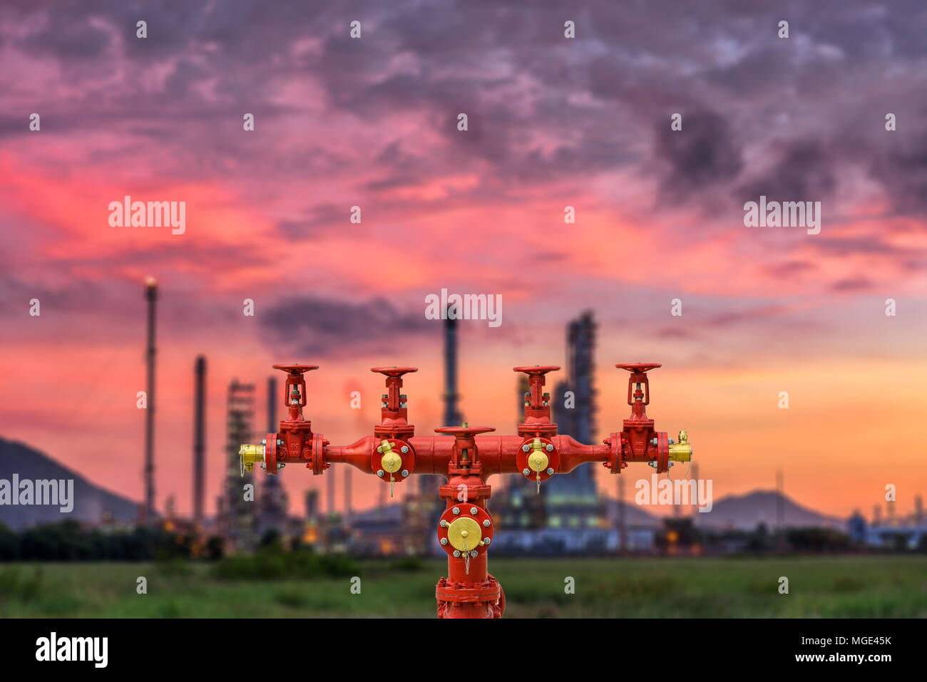 Fire hydrants and oil refinery plant blur background Stock Photo - Alamy