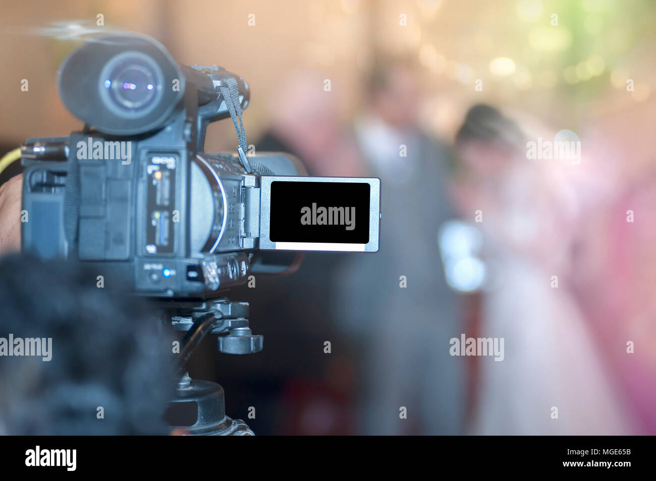 shooting bride and groom with video camera in wedding ceremony, focus ...