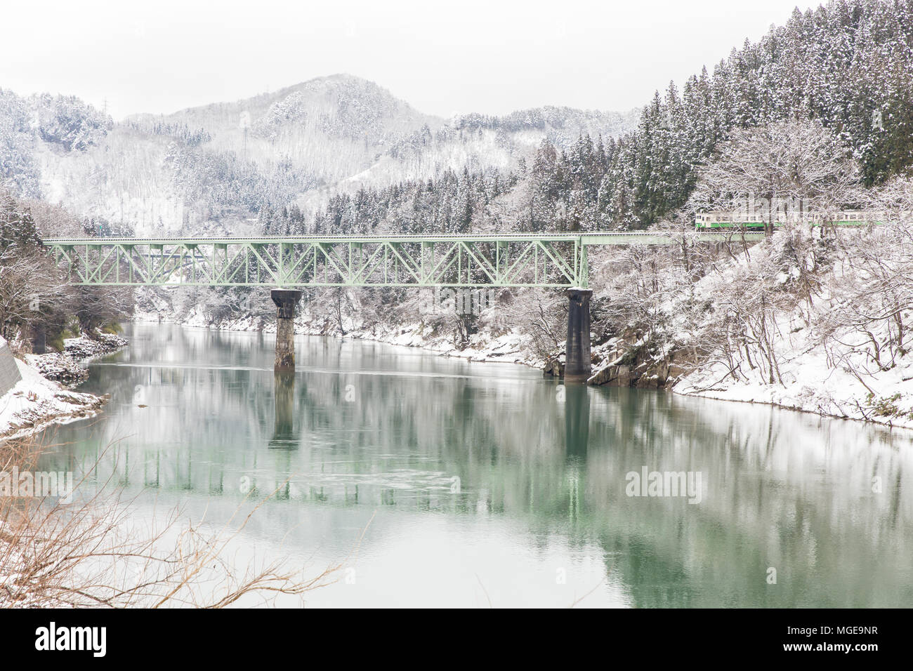Train in Winter landscape snow on bridge Stock Photo - Alamy