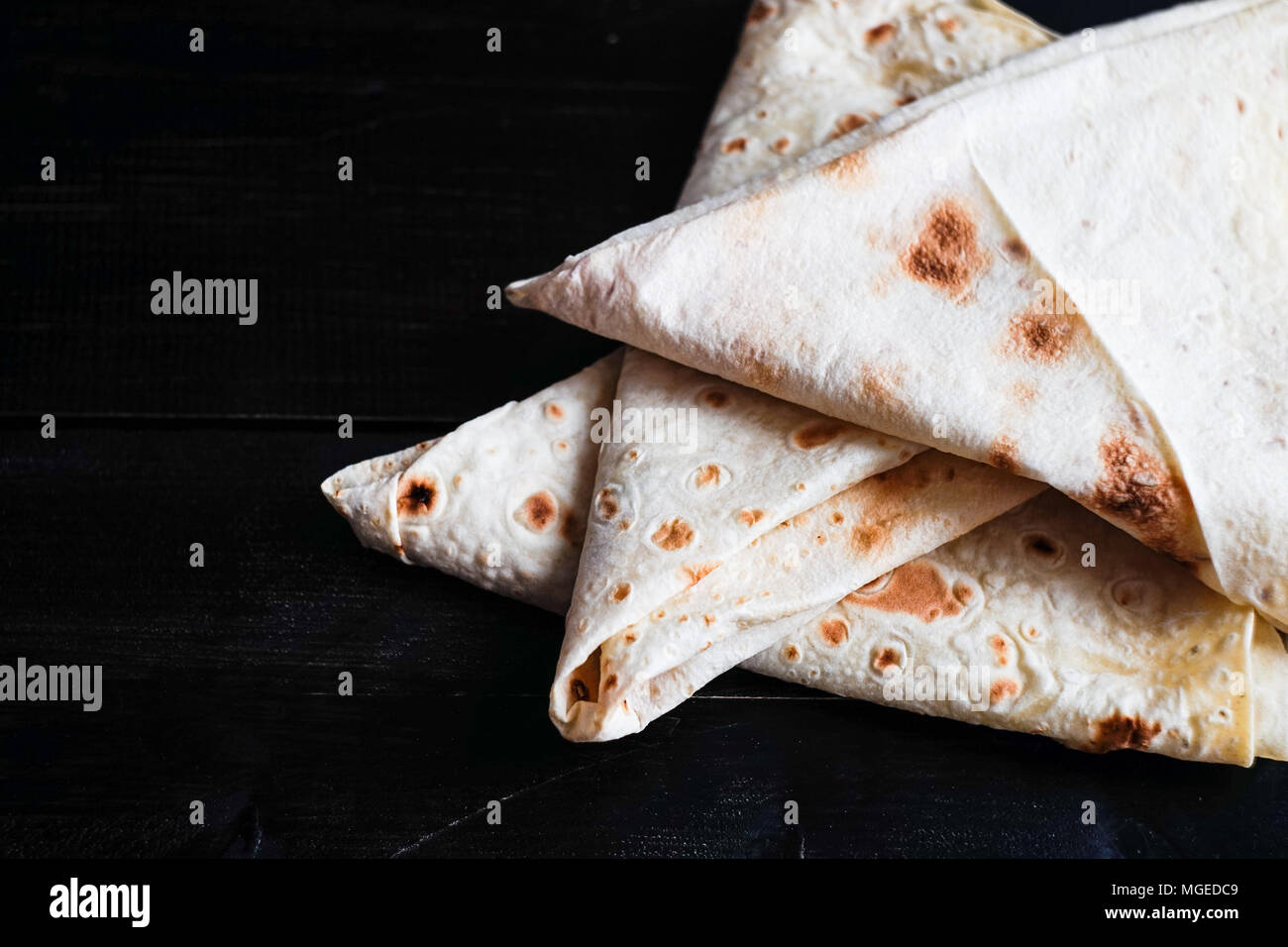 Traditional armenian flat bread - lavash on dark wooden table with ...