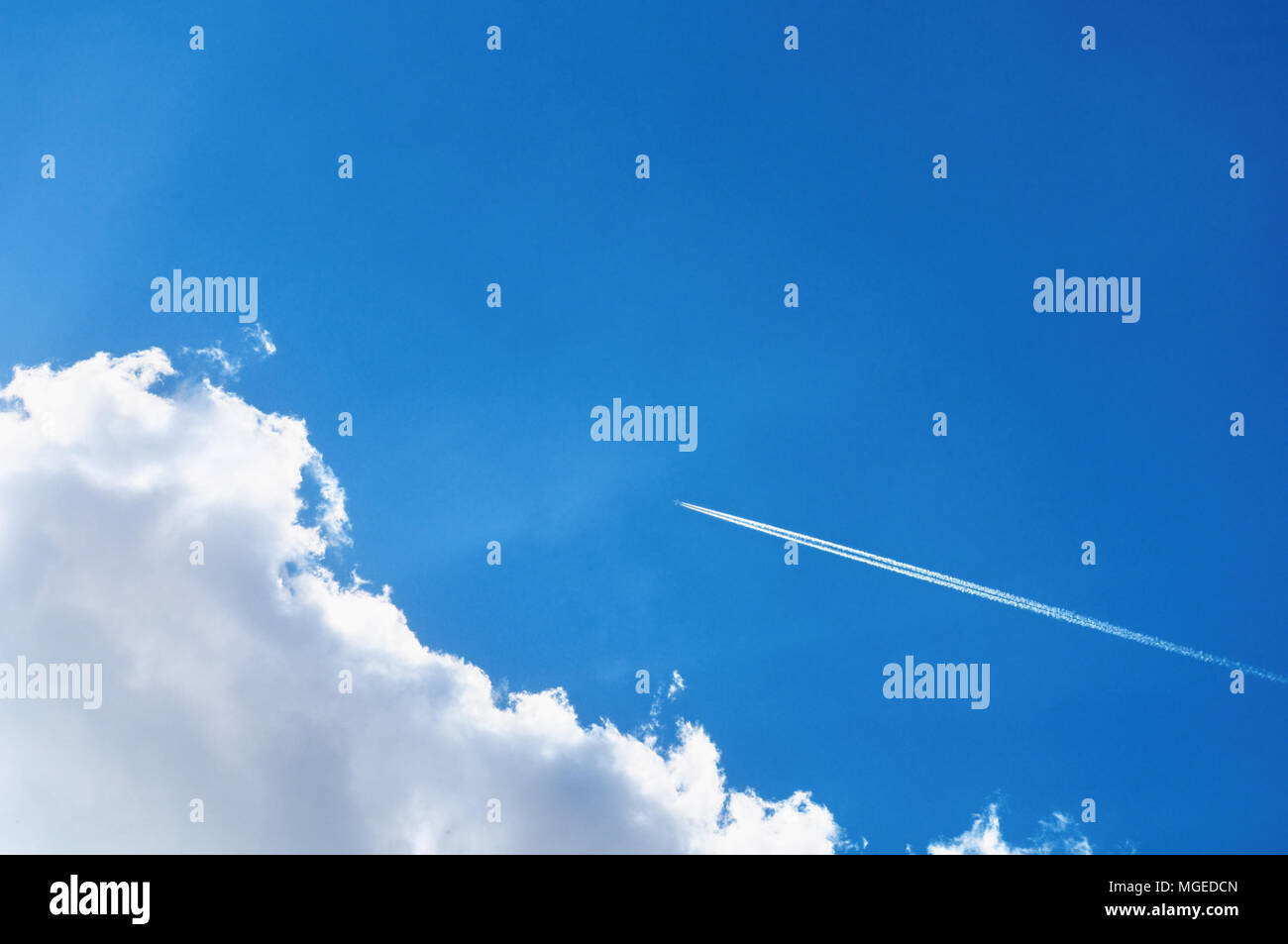 Blue sky background with a plane track. Jet of airplane in the blue sky ...