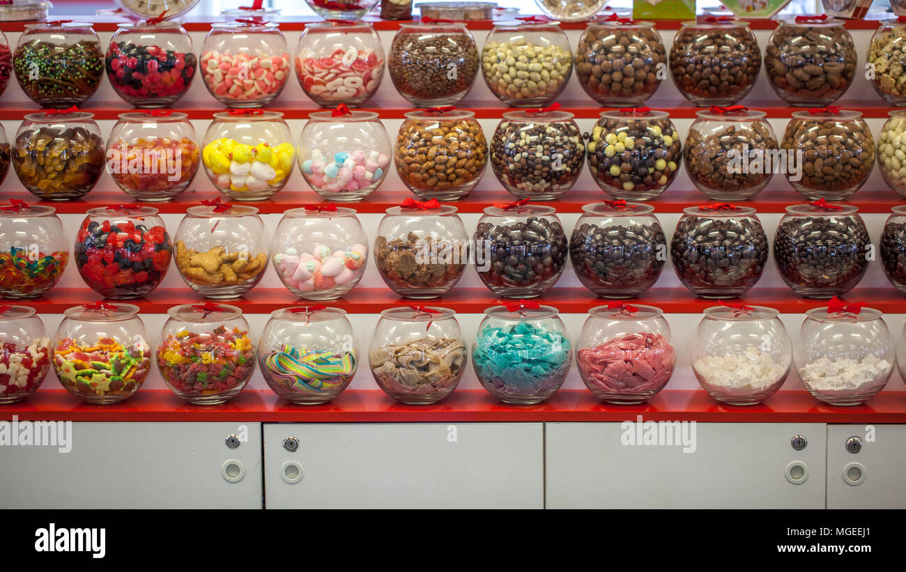 Filled glass candy jars at the fair Stock Photo - Alamy