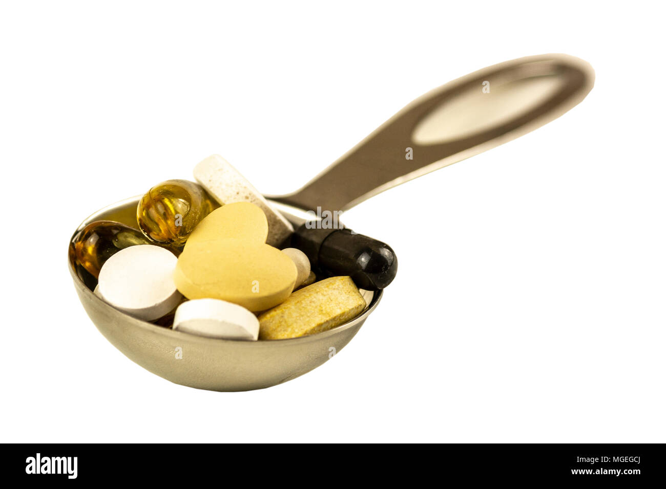 Multiple vitamins and nutrients in a measuring spoon (tablespoon Stock ...