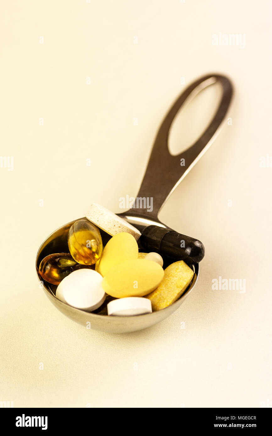 Multiple vitamins and nutrients in a measuring spoon (tablespoon Stock ...