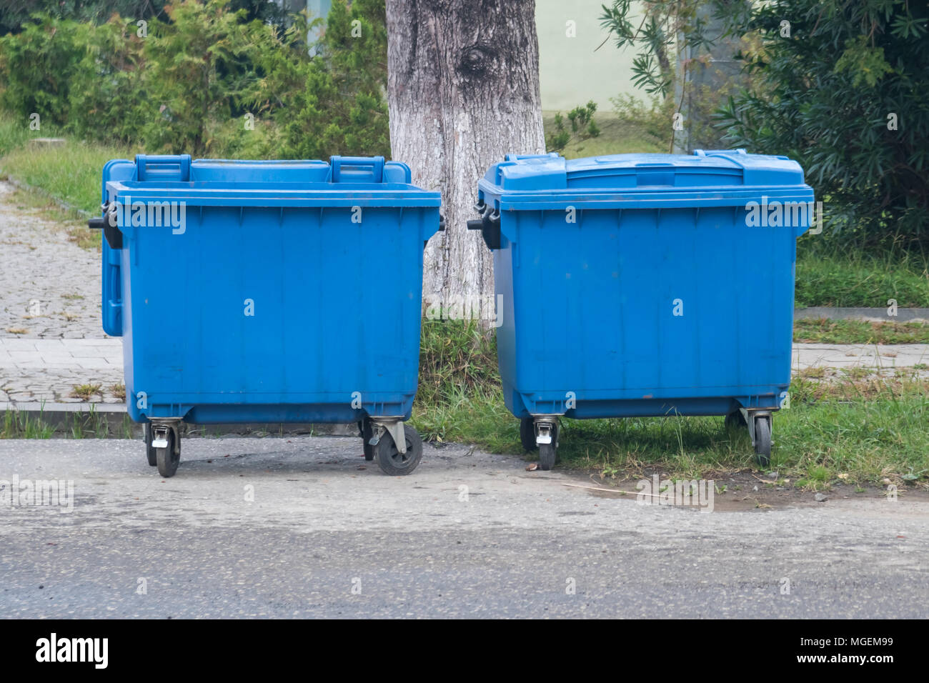 Big blue recycling containers on the street Stock Photo - Alamy