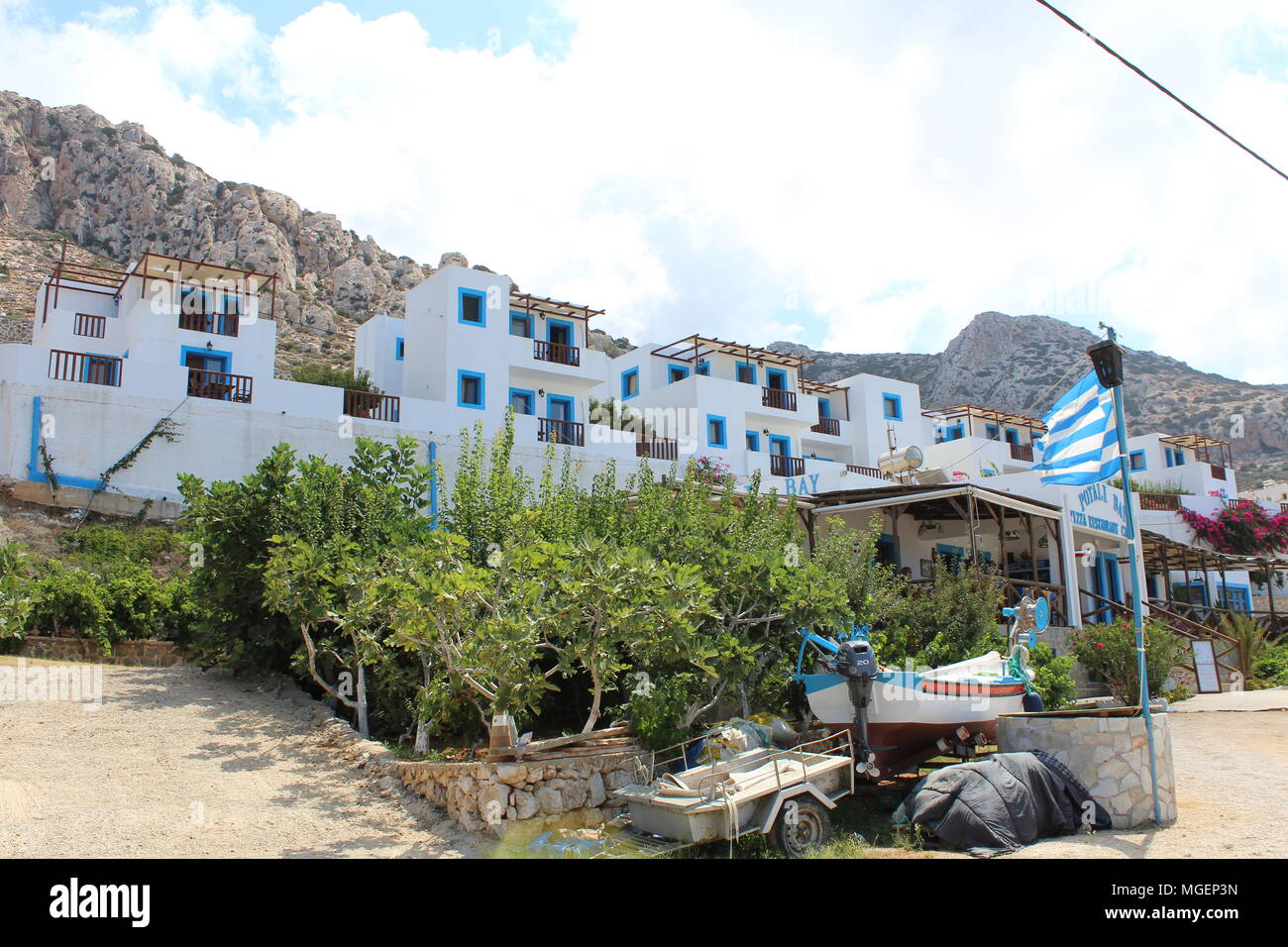Typical white and blue Greek houses with purple flowers that descend ...