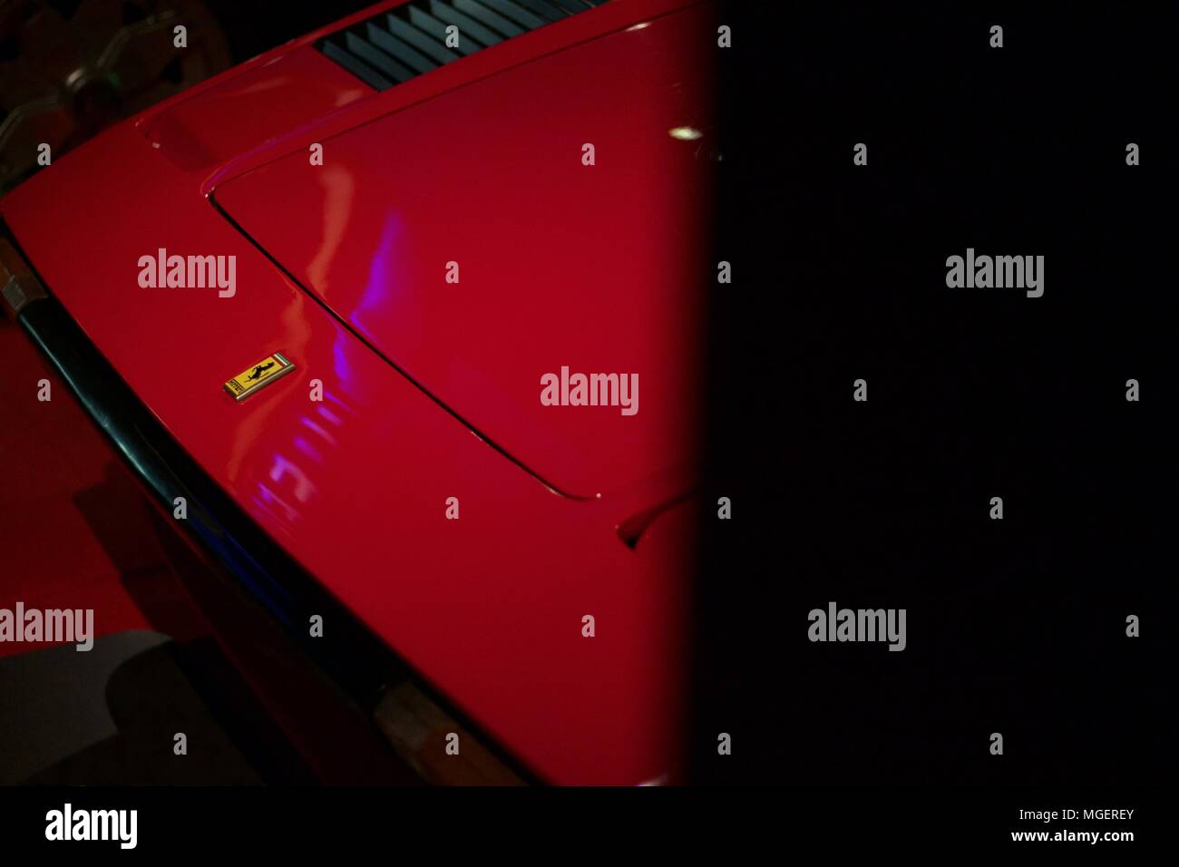 Red snout of a Ferrari Testarossa that protrudes from the wall, with ...