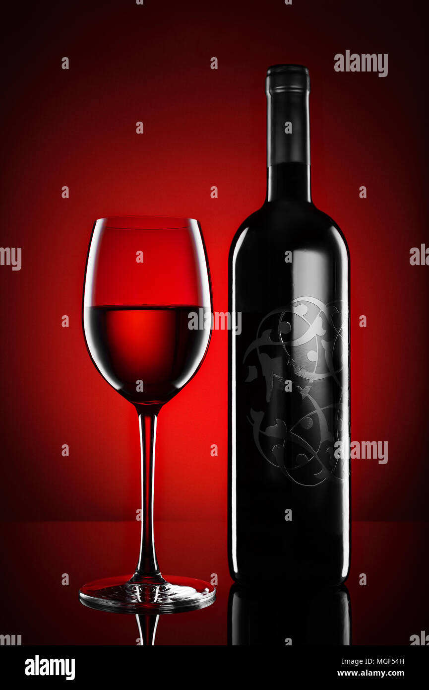 Classy bottle of red wine and wine glass on red background Stock Photo ...
