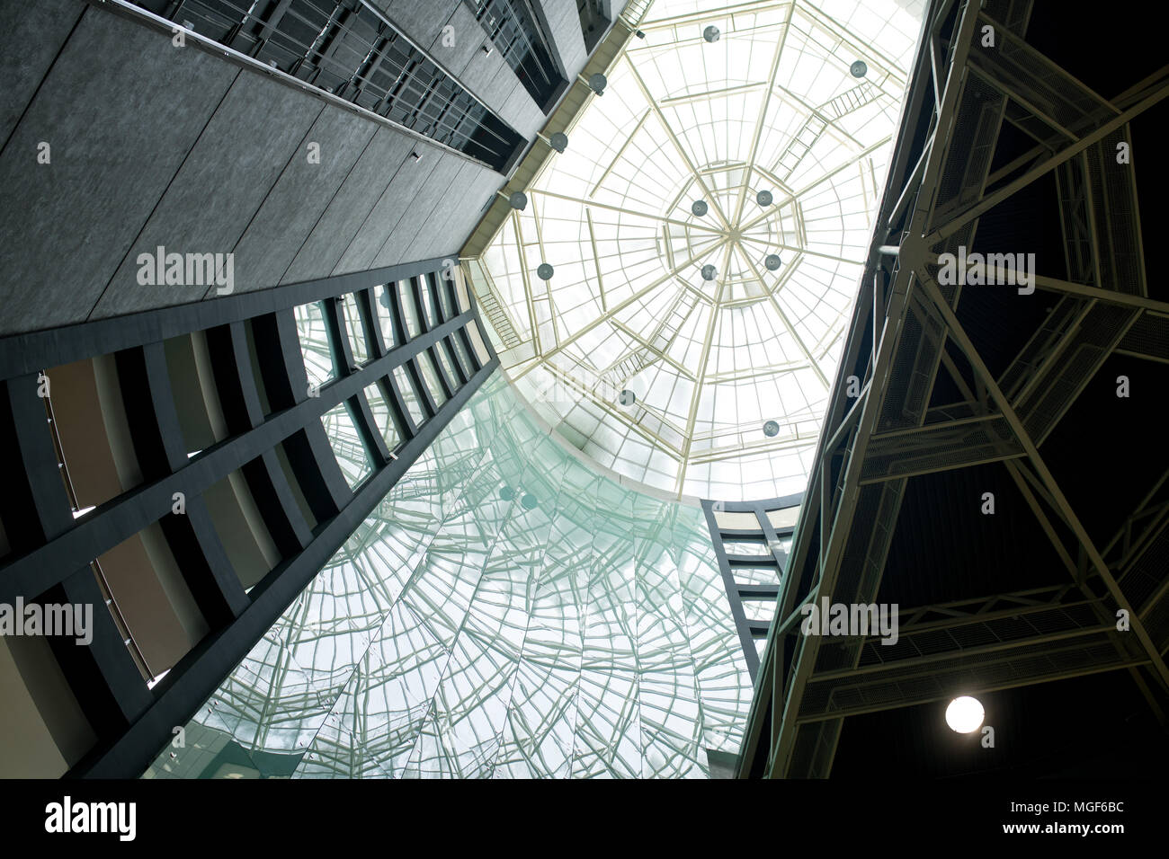 Directly below view of tall office building with panoramic roof, inside ...