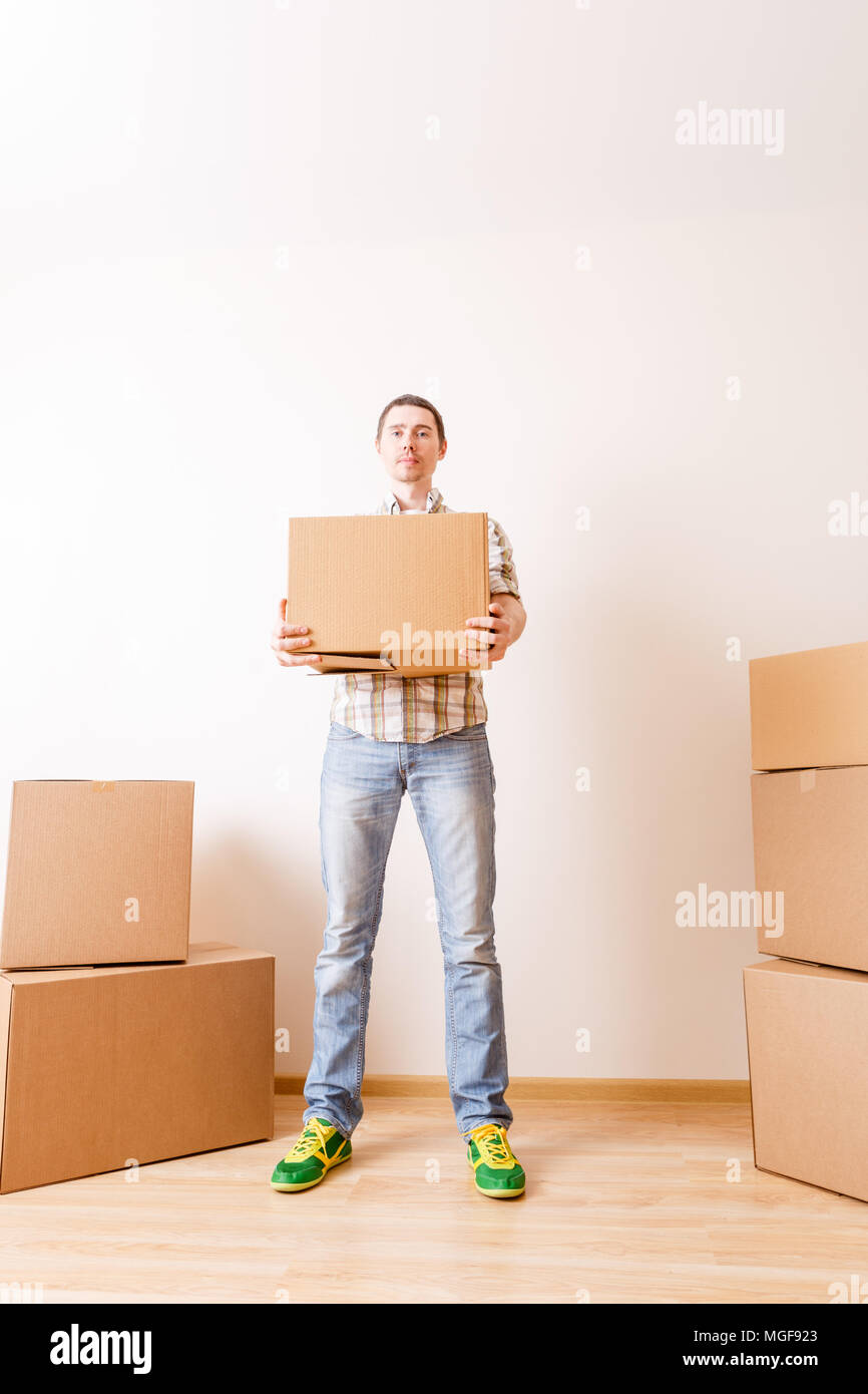 Photo of man standing among cardboard boxes Stock Photo - Alamy
