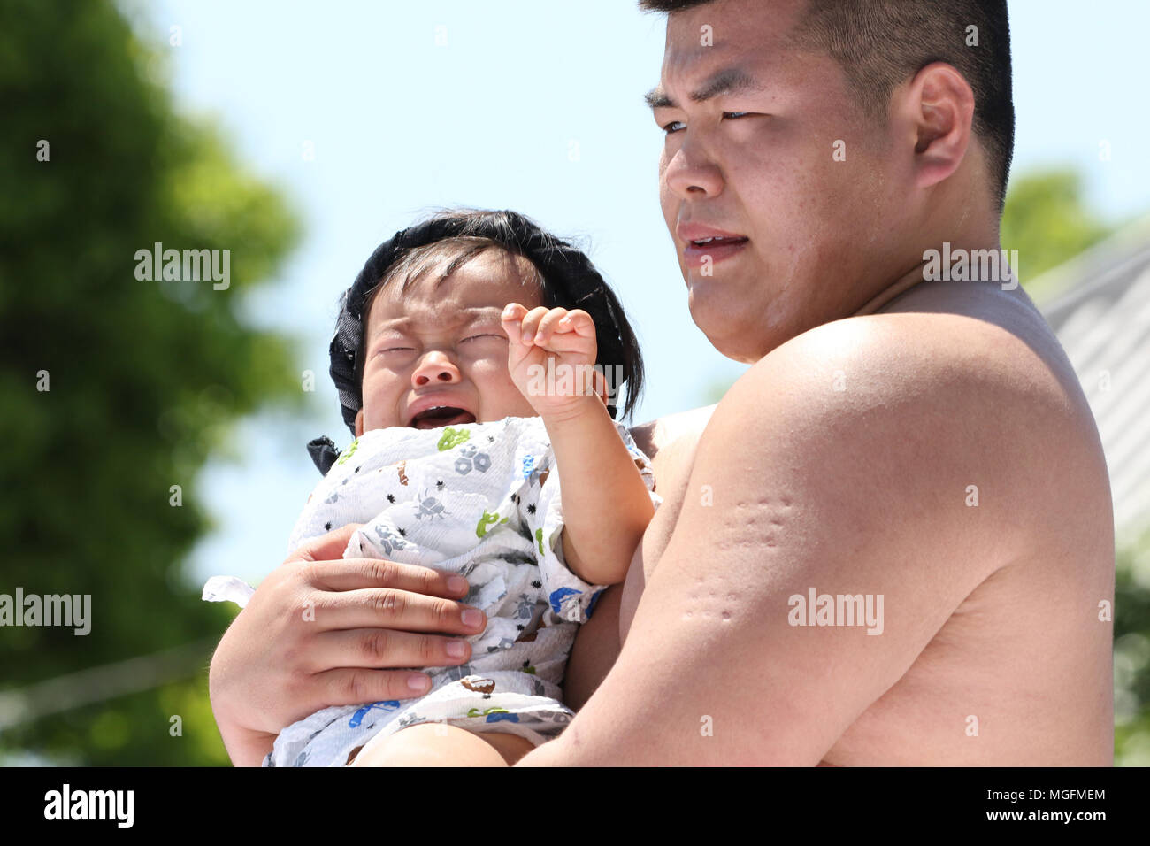 Tokyo, Japan. 28th Apr, 2018. A baby held by an amateur sumo wrestler ...