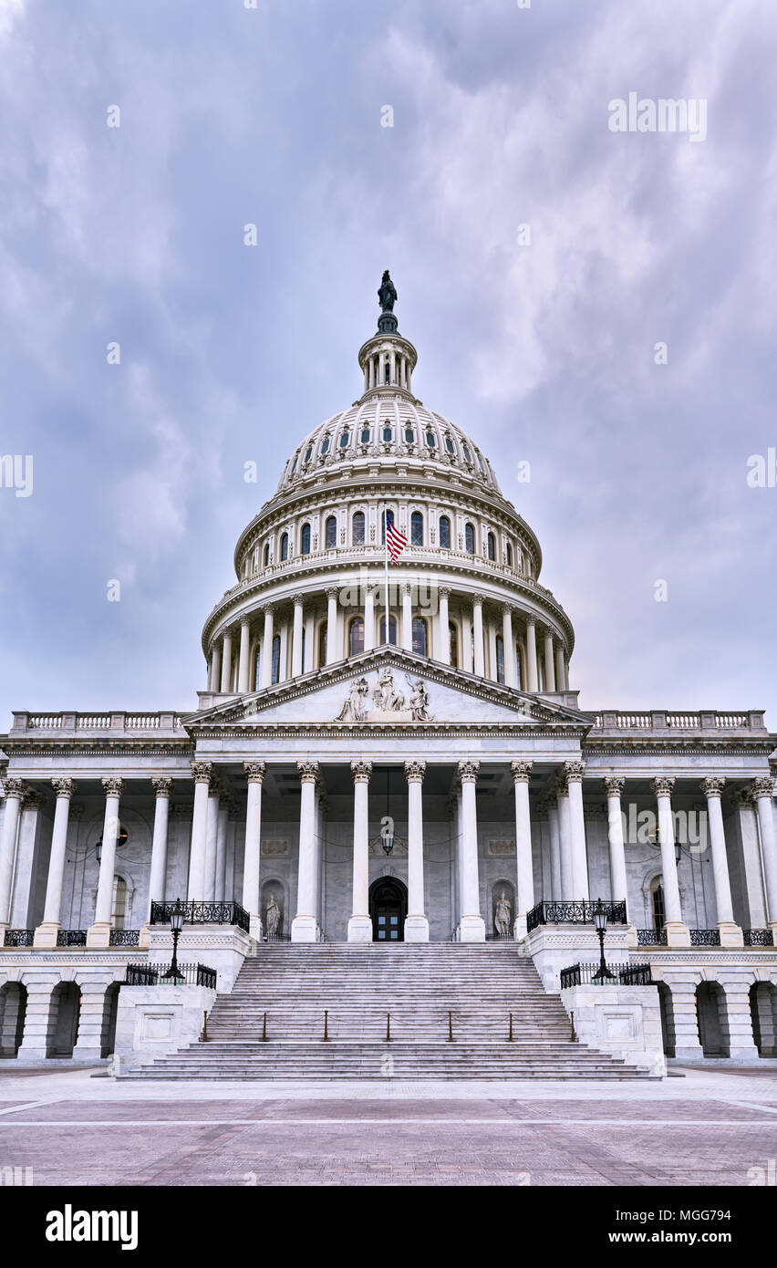 United States Capitol Building facade and empty plaza on a dark cloudy ...