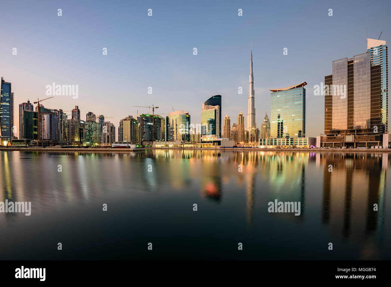 Downtown Dubai’s skyline, including the iconic Burj Khalifa, reflects ...