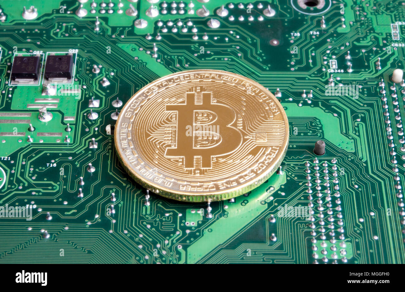 Abstract golden bitcoin on printed circuit board Stock Photo - Alamy