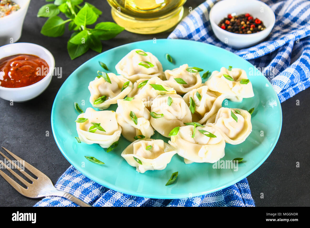 Homemade ready dumplings on a gray concrete table Stock Photo - Alamy
