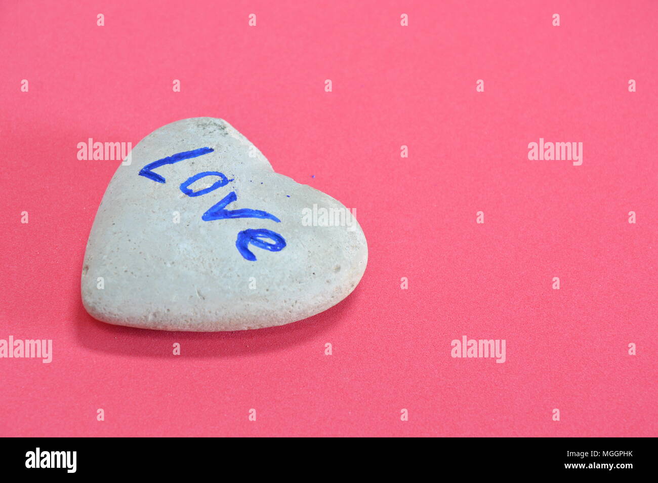 heart rock on red background Stock Photo - Alamy