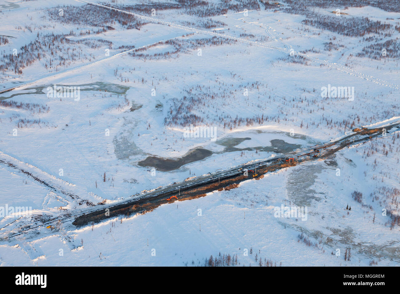 Excavators digging the trench for setting gas pipeline, bird's eye view ...