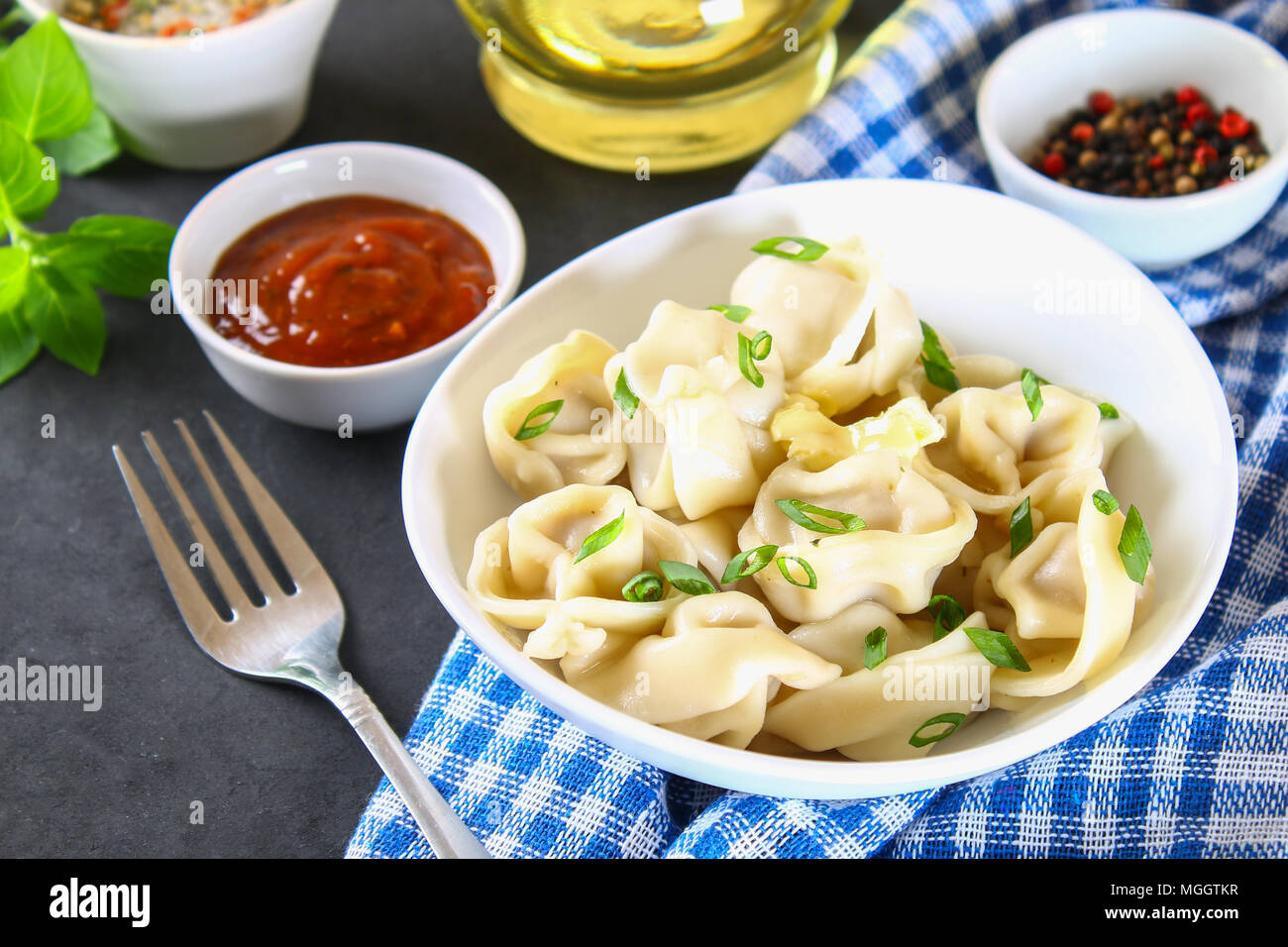 Homemade ready dumplings on a gray concrete table Stock Photo - Alamy
