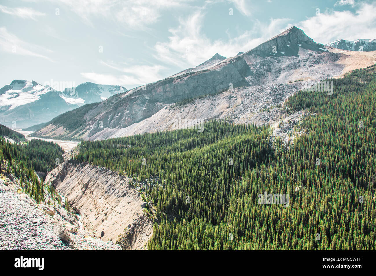 Snow capped mountain view across the valley Stock Photo - Alamy
