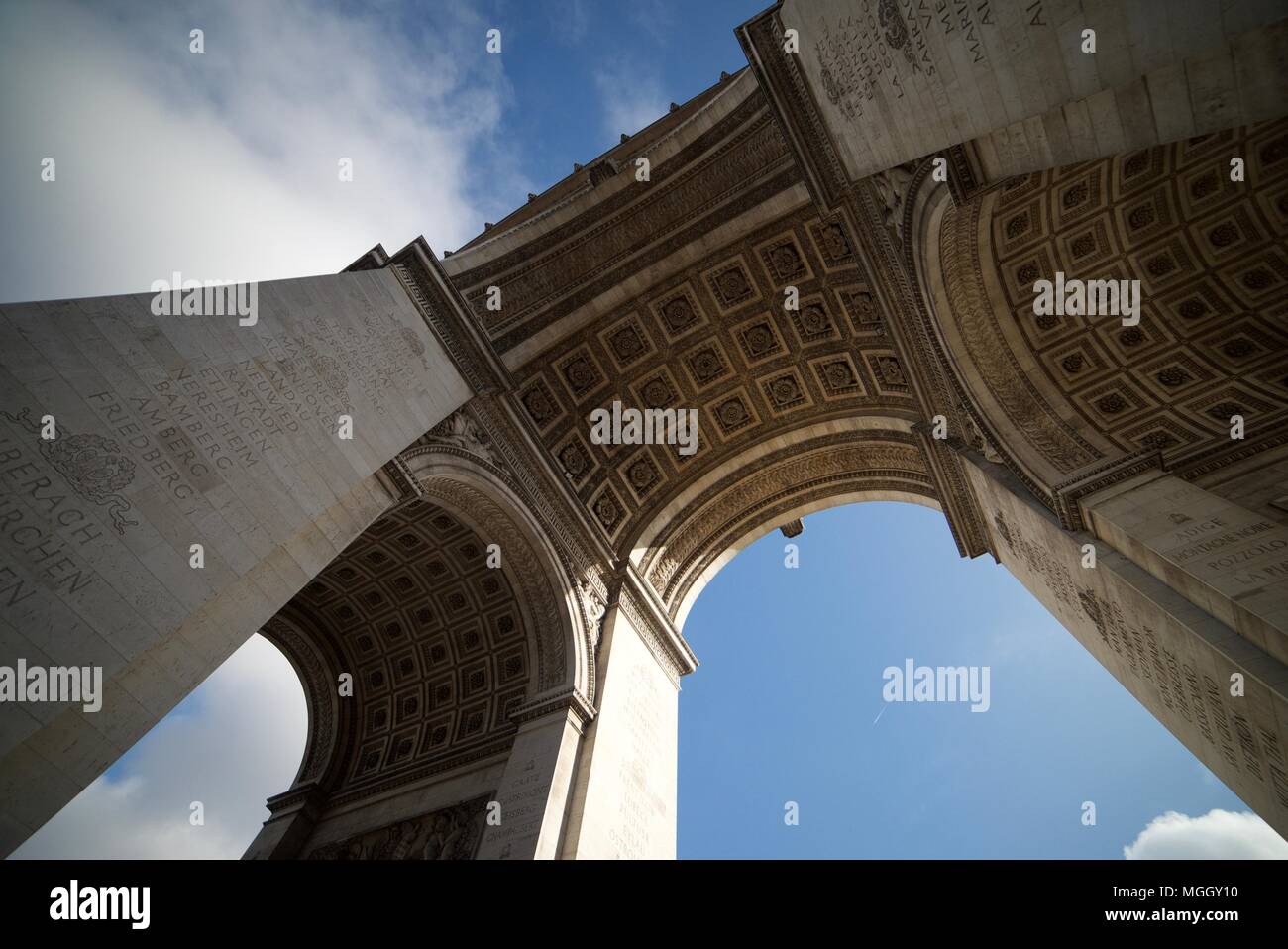 Wide-angle view looking up at architecture inside The Arc de Triomphe ...