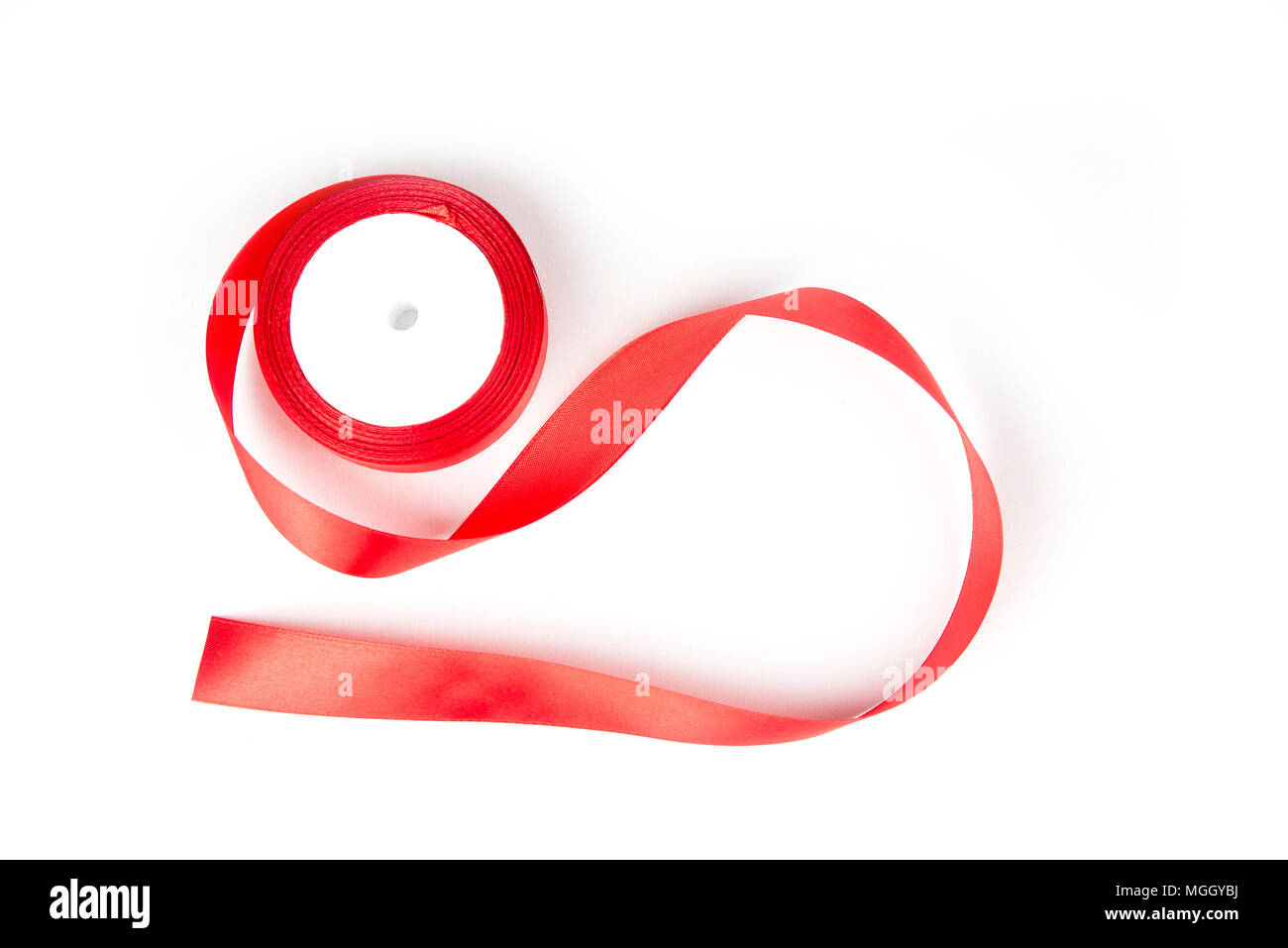 Roll of red ribbon on the white background Stock Photo - Alamy