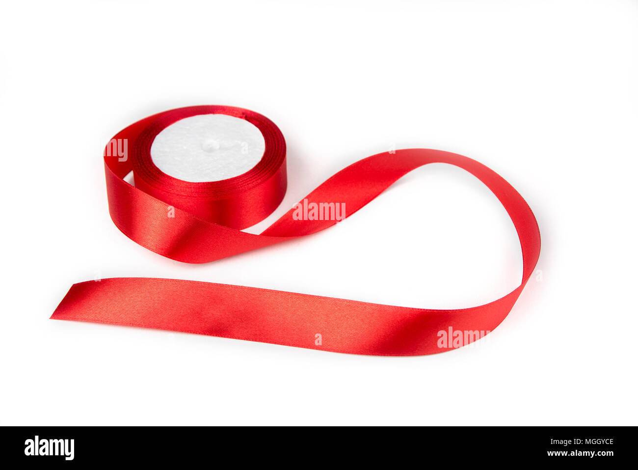Roll of red ribbon on the white background Stock Photo - Alamy