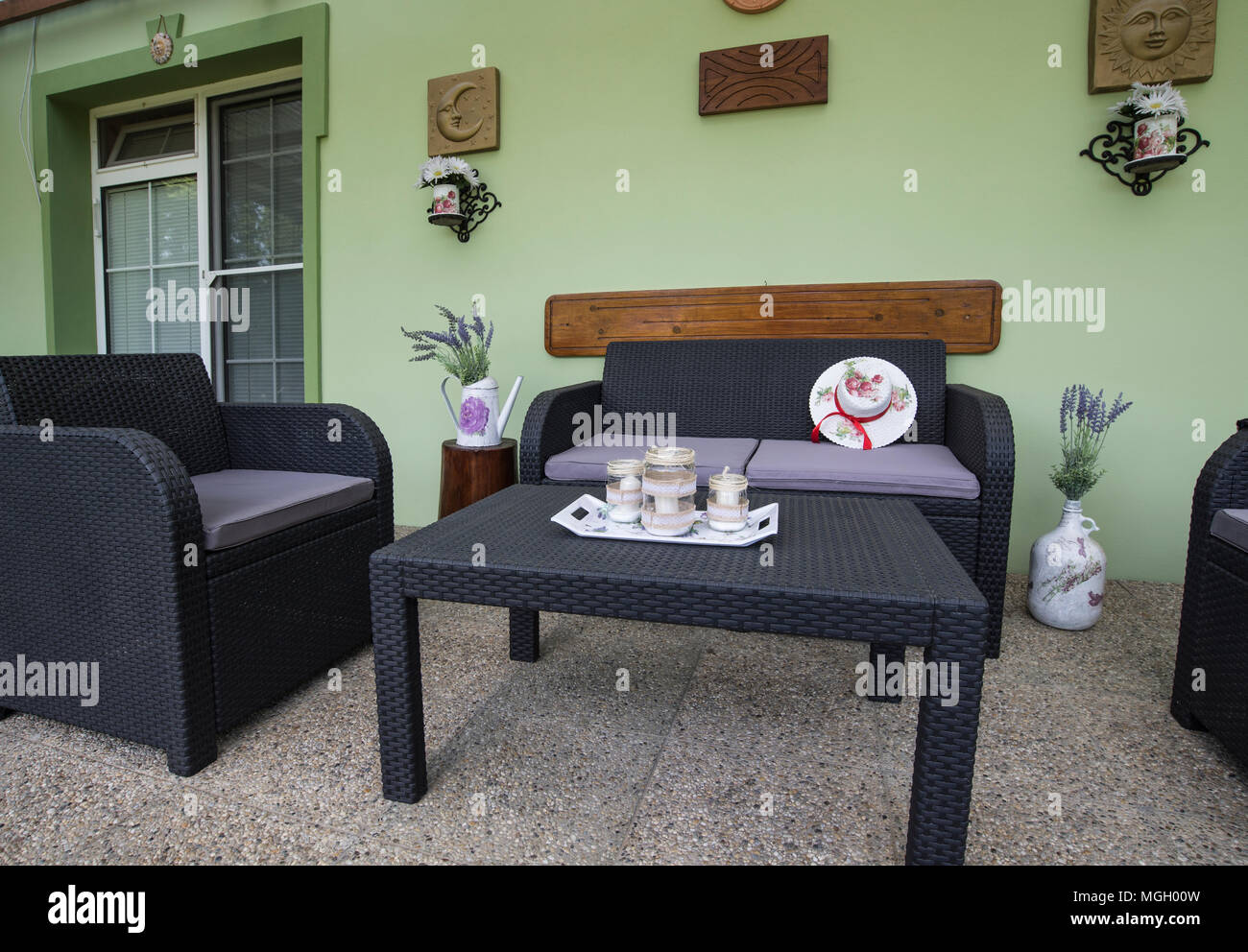 Plastic rattan patio furniture with rustic decoration Stock Photo - Alamy
