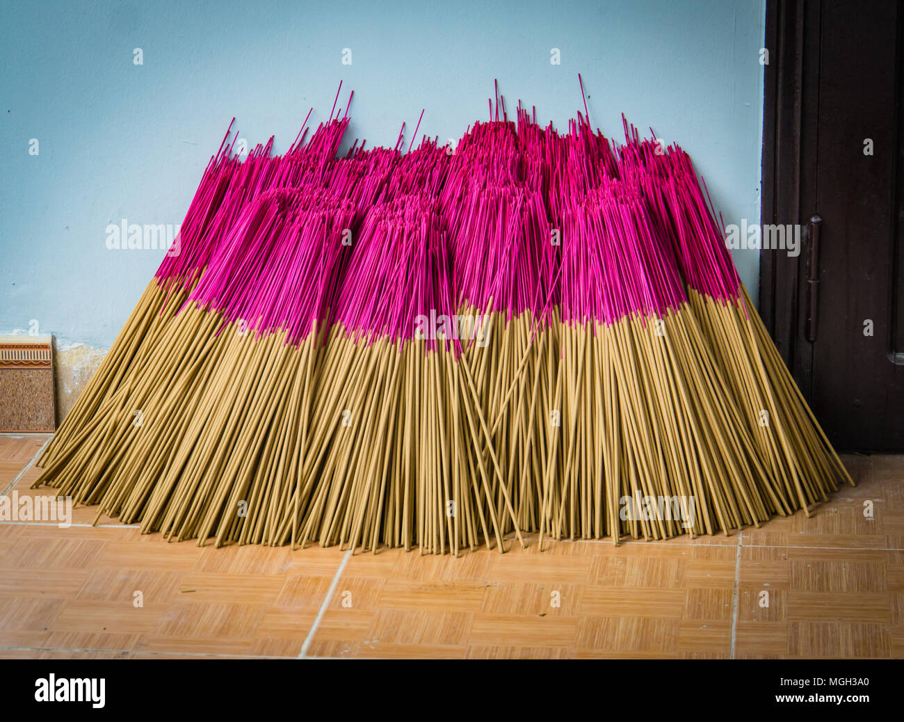 incense sticks brightly painted pink laid out in patio to dry Stock ...