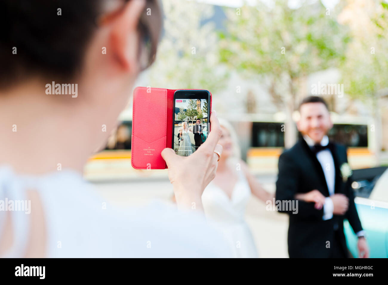 Photo of bride and groom on a smartphone Stock Photo - Alamy